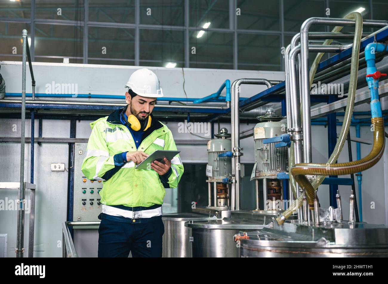 Caucasian technician engineer man in uniform with tablet checking and ...