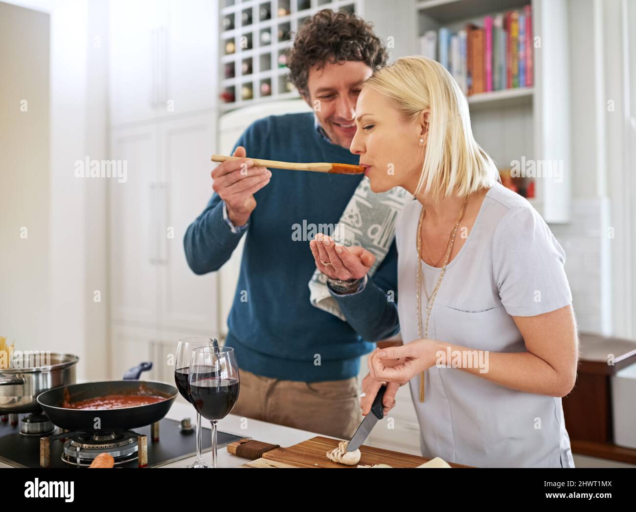The kitchen is the heart of this home. Shot of a happy couple cooking ...