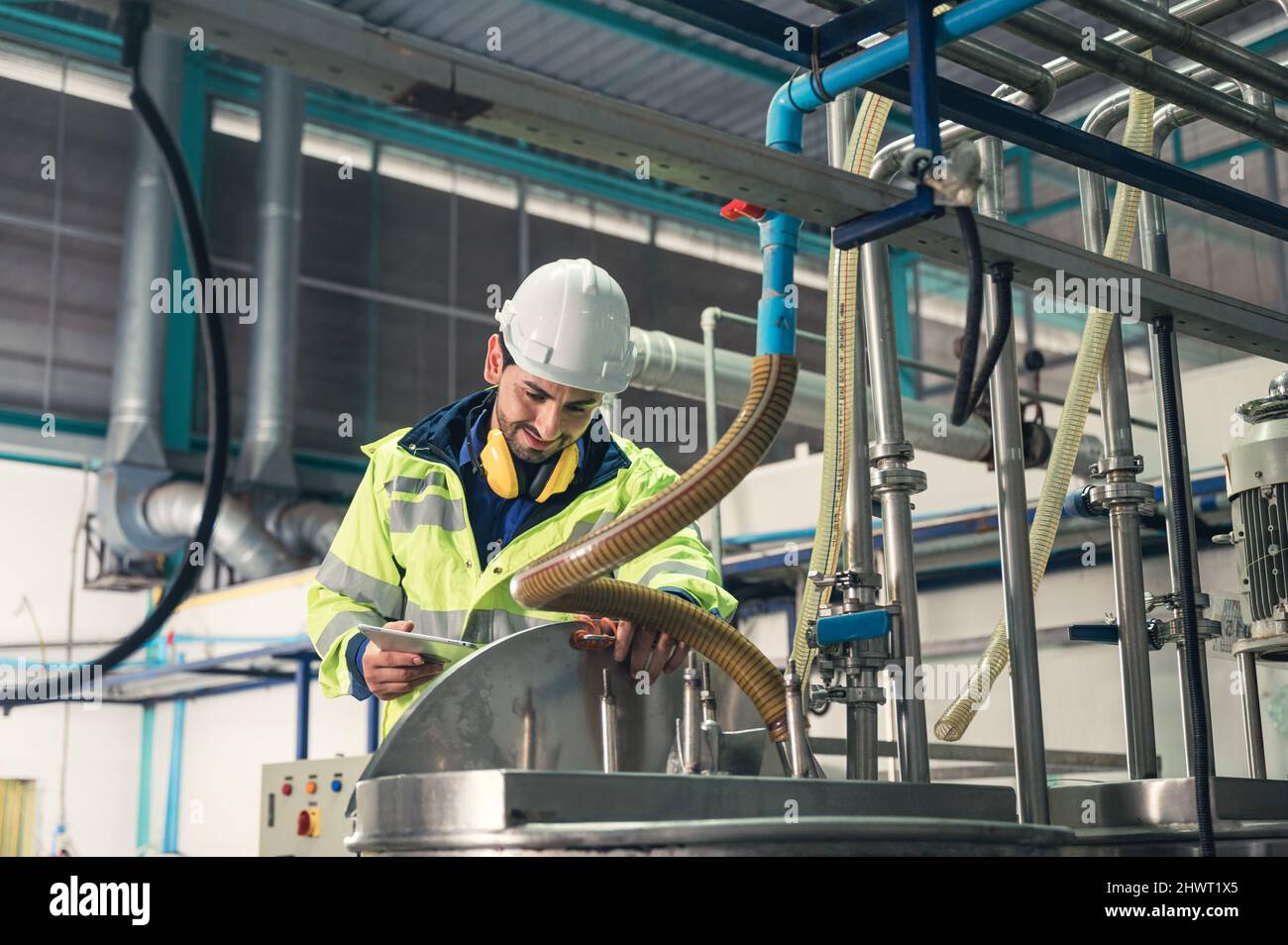 Caucasian technician engineer man in uniform with tablet checking and ...
