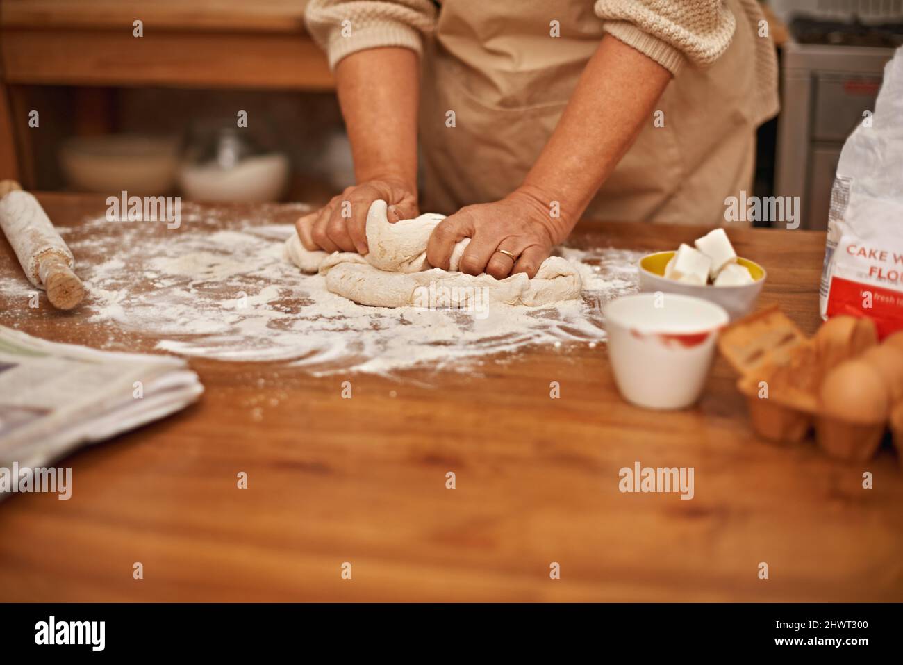 Made with love.... A cropped view of hands working the dough while ...