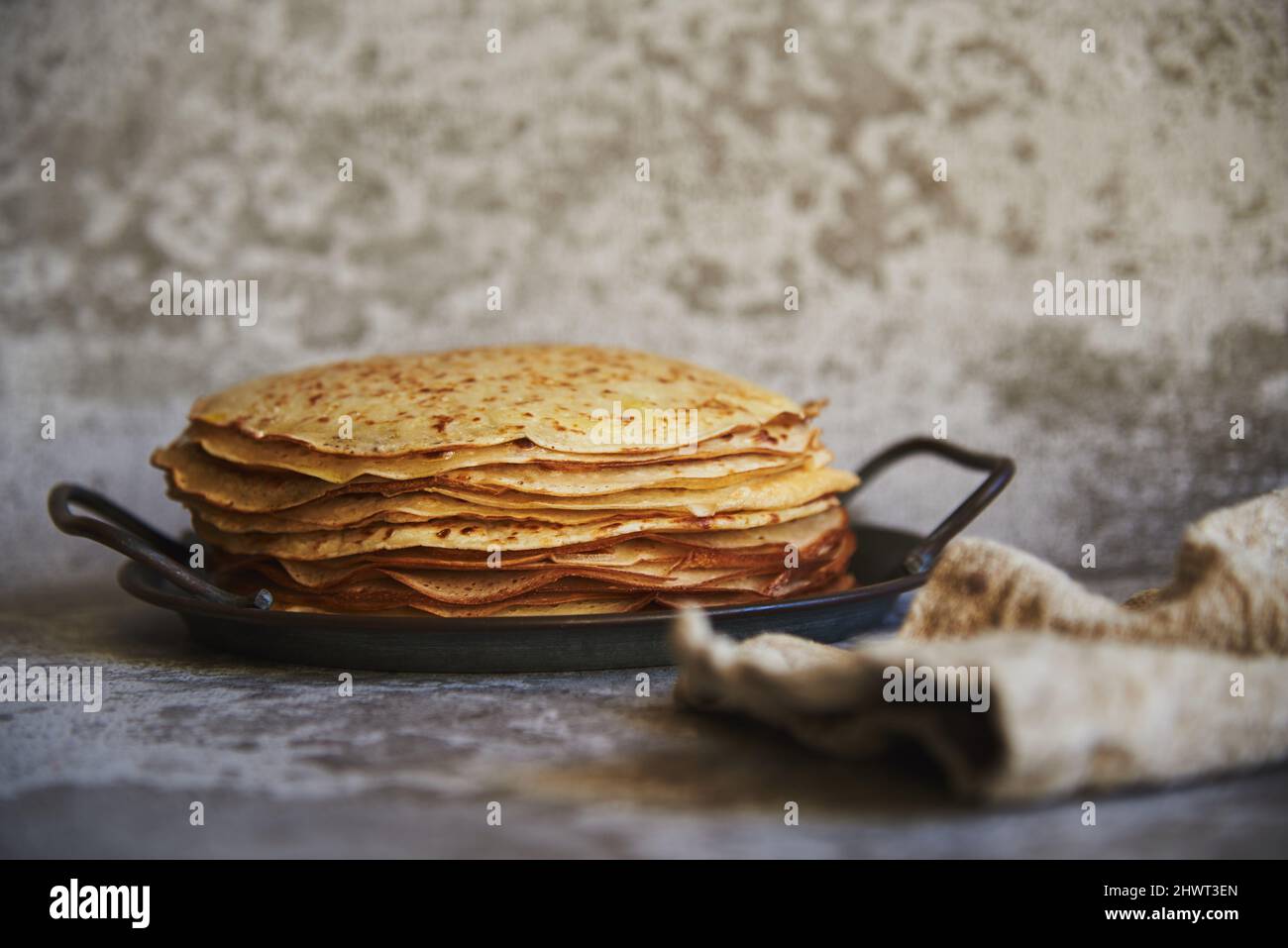Delicious pancakes on a vintage metal platter on a concrete surface ...