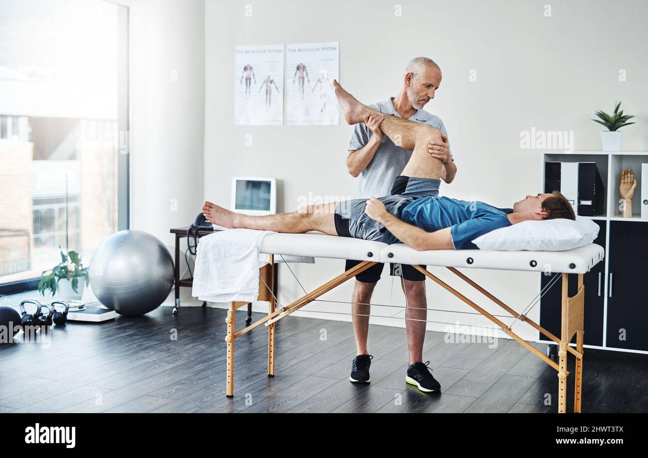 How does it feel now. Shot of a physiotherapist treating a patient ...