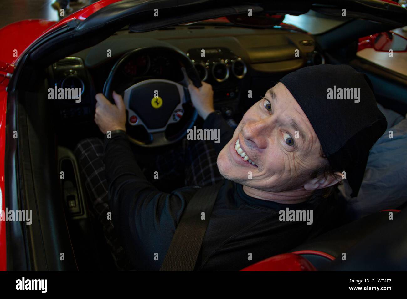 Happy man sitting in a Ferrari car. Ferrari Car Engine Stock Photo - Alamy