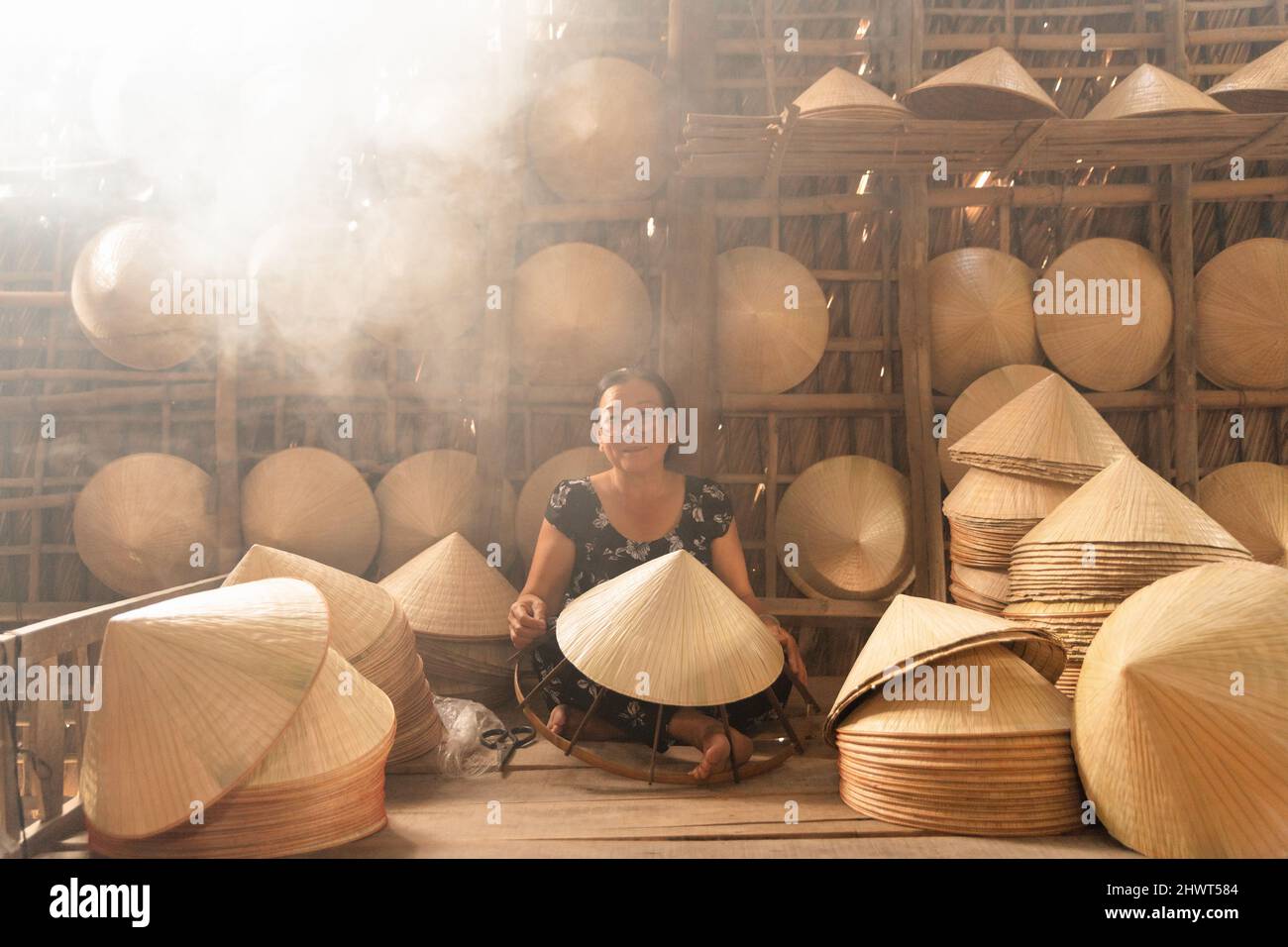 old vietnamese woman making a traditional conical hat at her home Stock ...