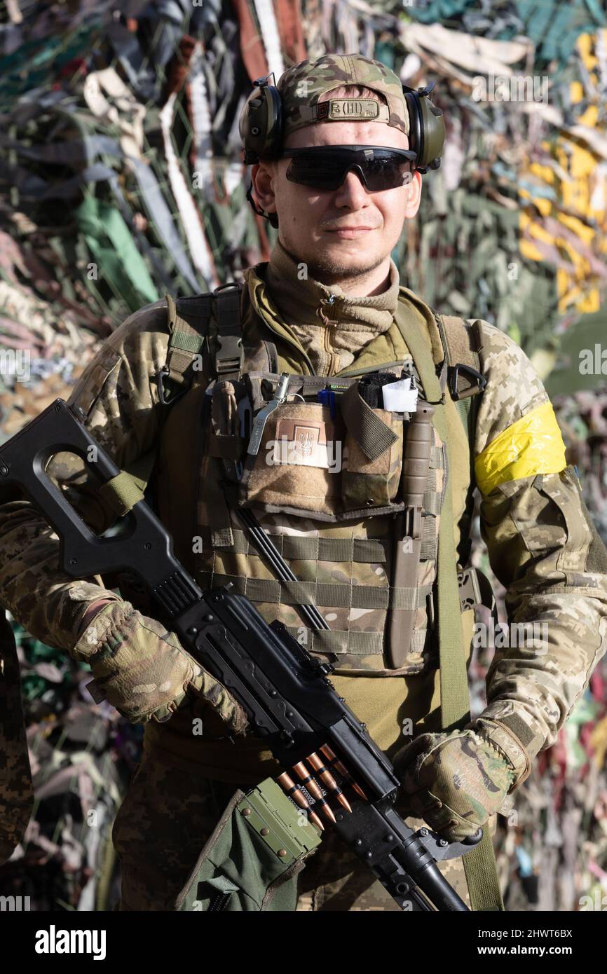 A member of the Kyiv defence battalion seen holding his refile ready to ...