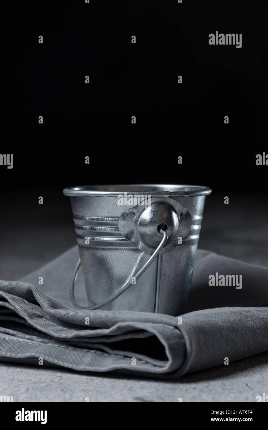 Mini aluminium bucket on the table, space fot text Stock Photo - Alamy