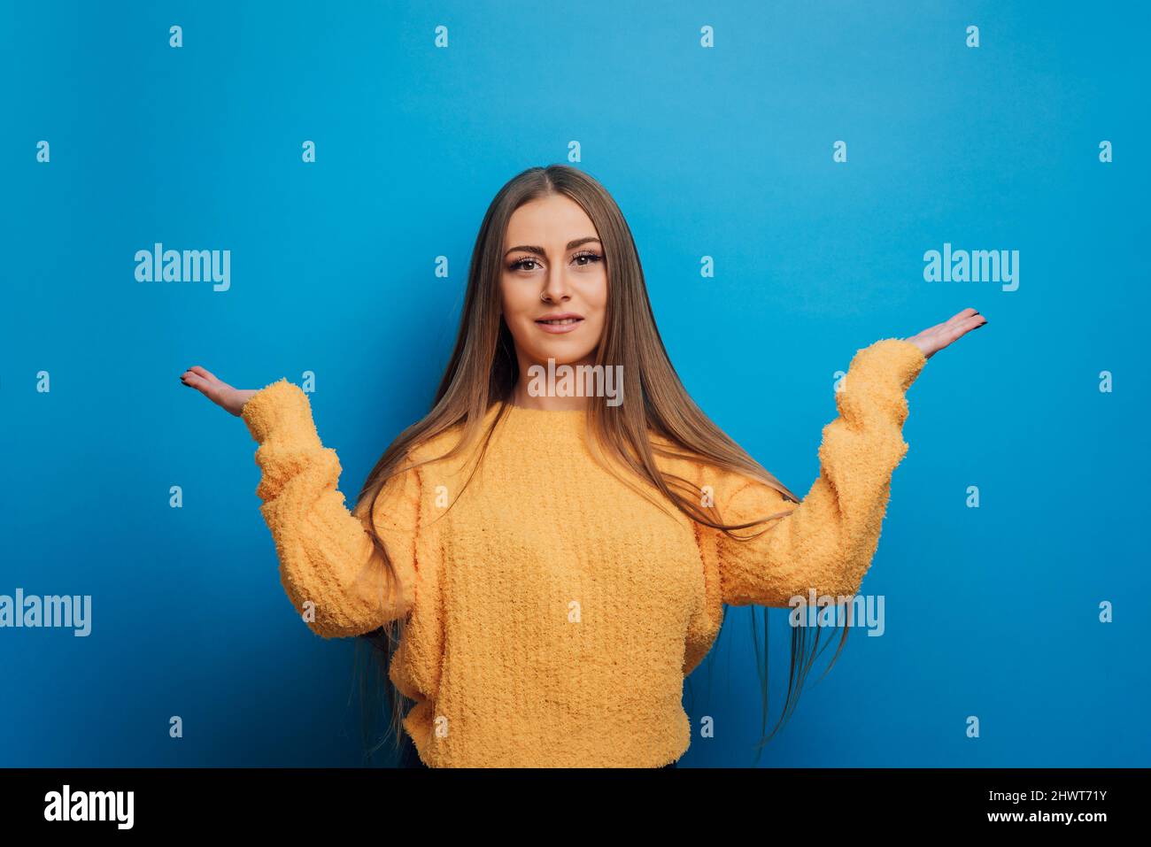 Woman showing something on her empty hands while standing over an ...