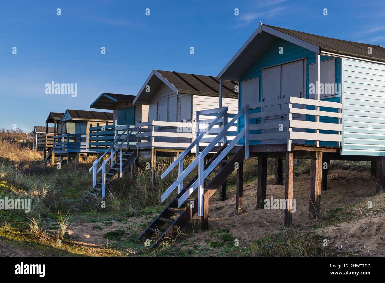 Row of beach huts in the sand dunes seen at Old Hunstanton in Norfolk ...
