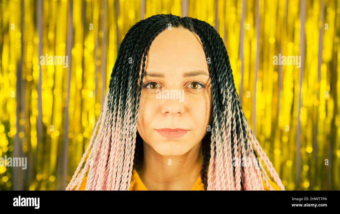 Pretty female with multicolored hairstyle smiles, expressing positive ...