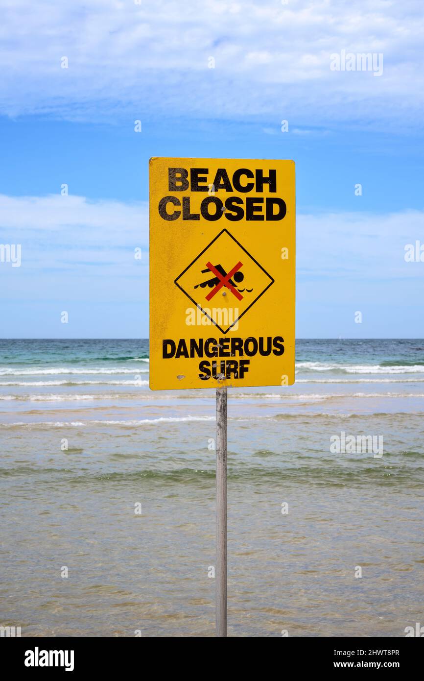 Yellow beach closed sign Stock Photo - Alamy