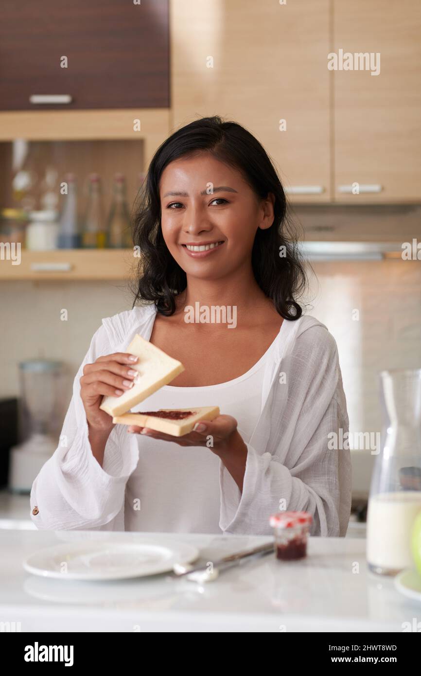 Woman making toast strawberry jam hi-res stock photography and images ...