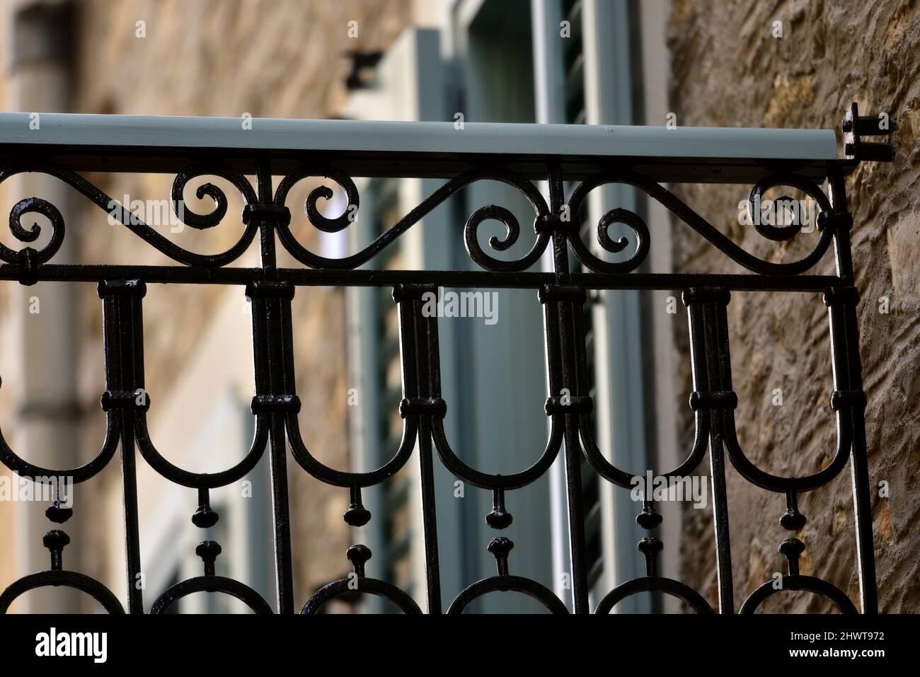 Old rural house handcrafted wrought iron balcony railing against an ...