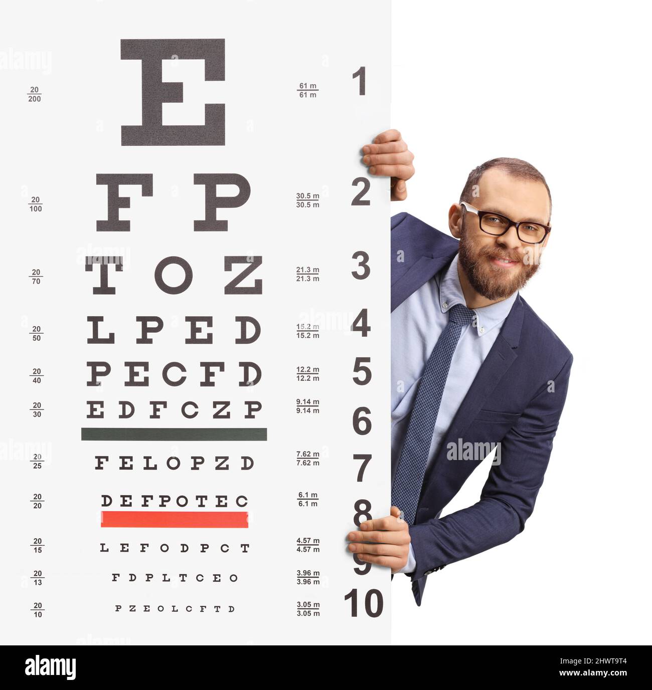Young man with glasses peeking from behind an eye vision examination ...