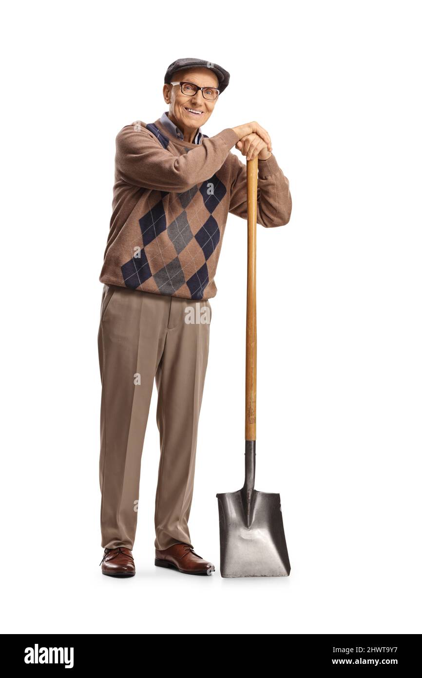 Full length portrait of an elderly casual man leaning on a shovel ...