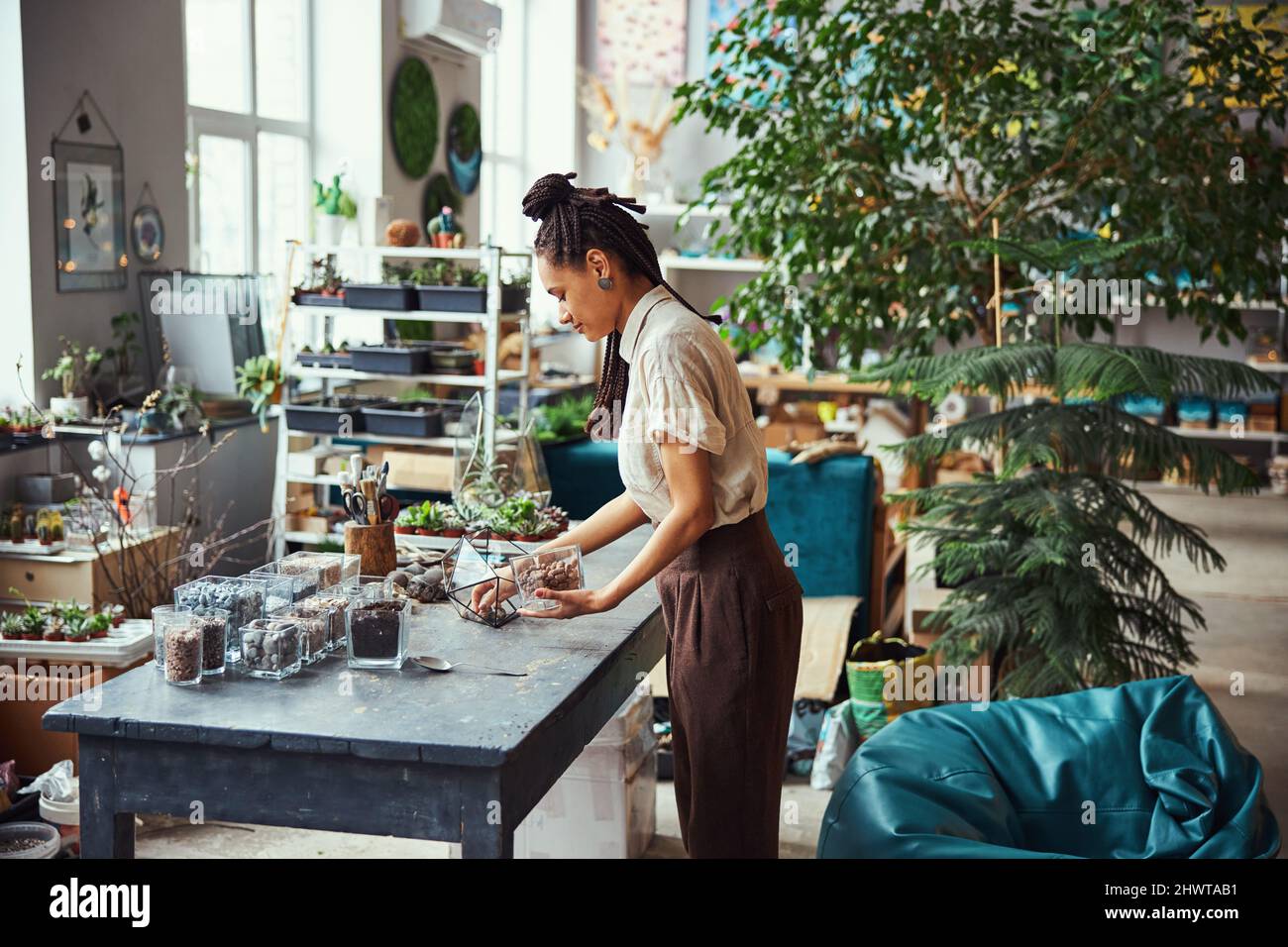 Florist creating a florarium in her workshop Stock Photo - Alamy
