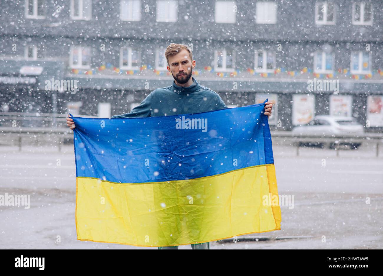 Young angry man holds ukrainian flag in his hands and protests against ...