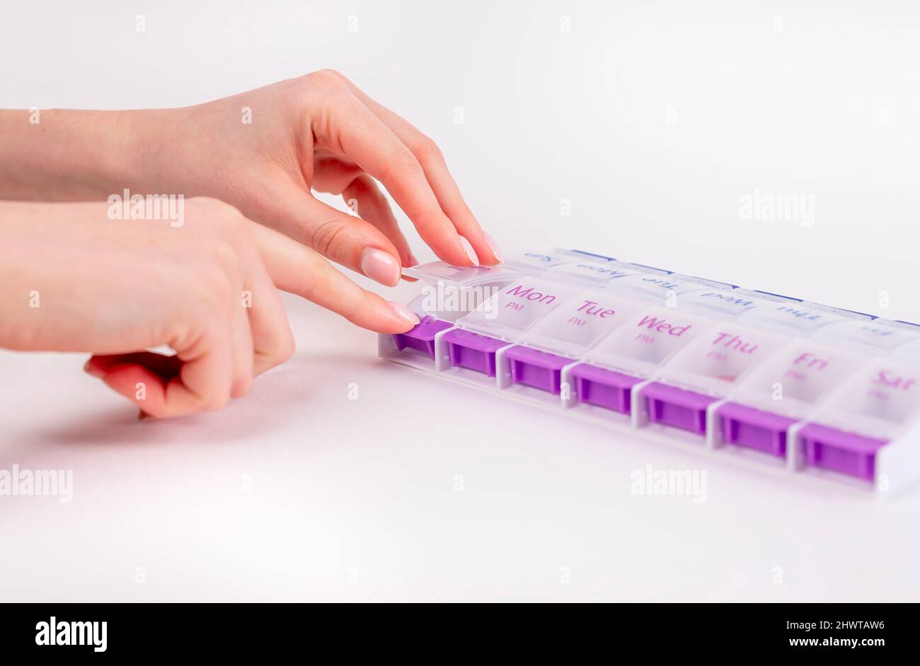 Woman hands opening pills box. Daily treatment and medication concept ...