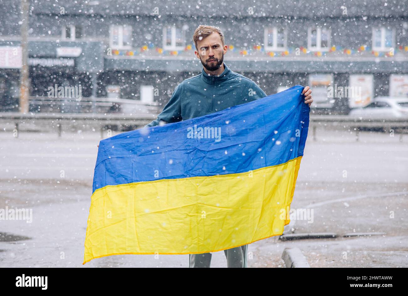 Young angry man holds ukrainian flag in his hands and protests against ...