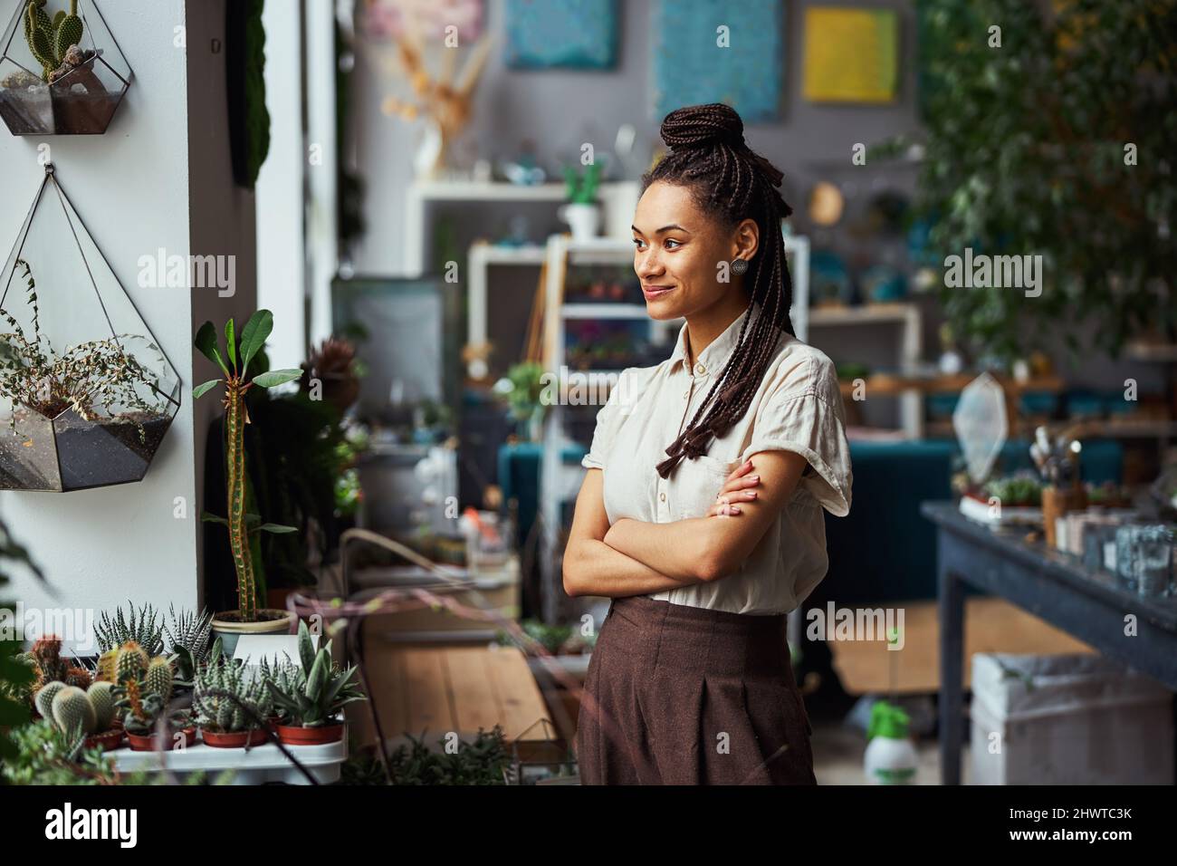 Dreamy female florist looking out of the window Stock Photo - Alamy