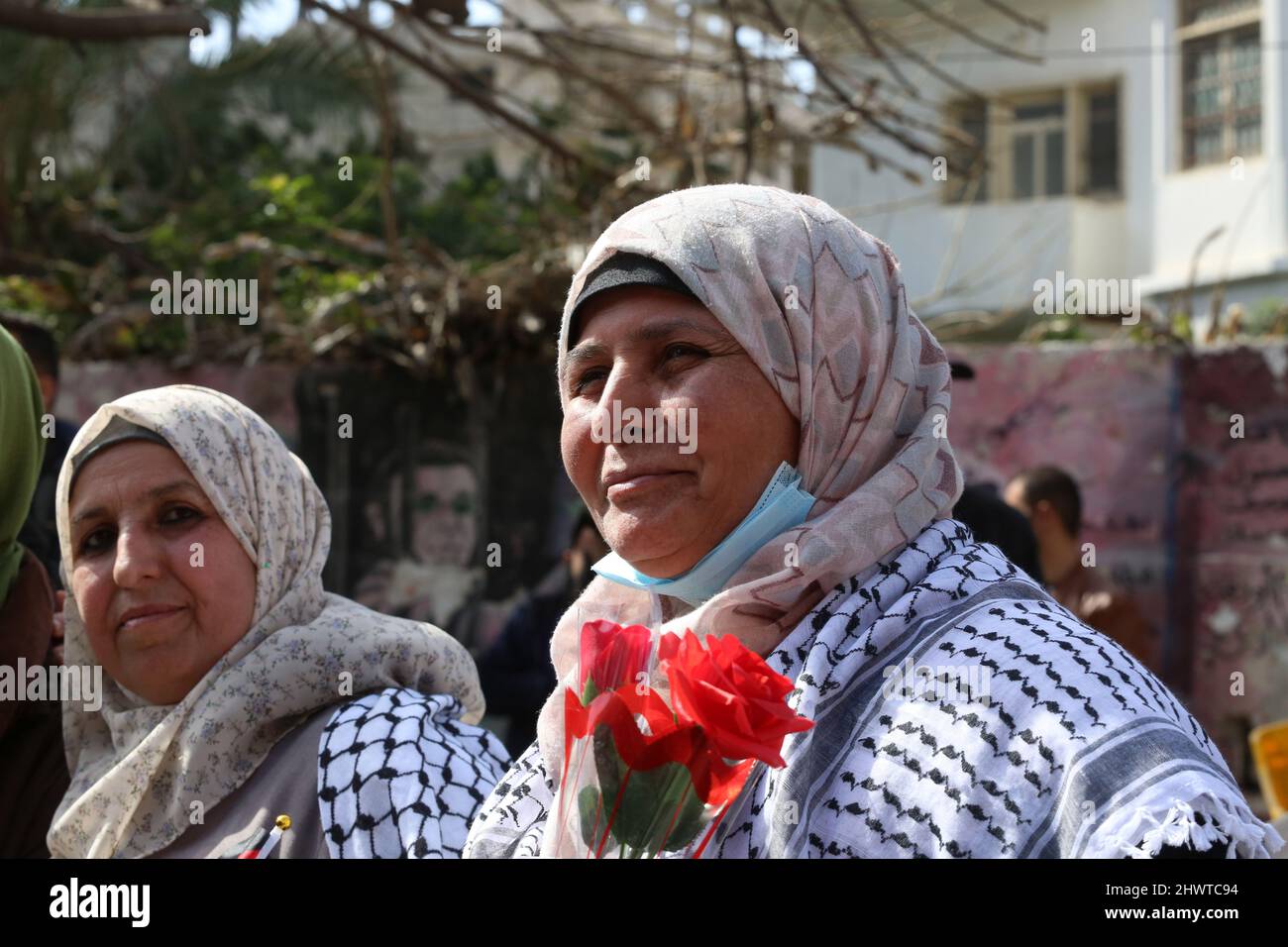 Gaza, Palestine. 07th Mar, 2022. A Palestinian woman holds a flower ...