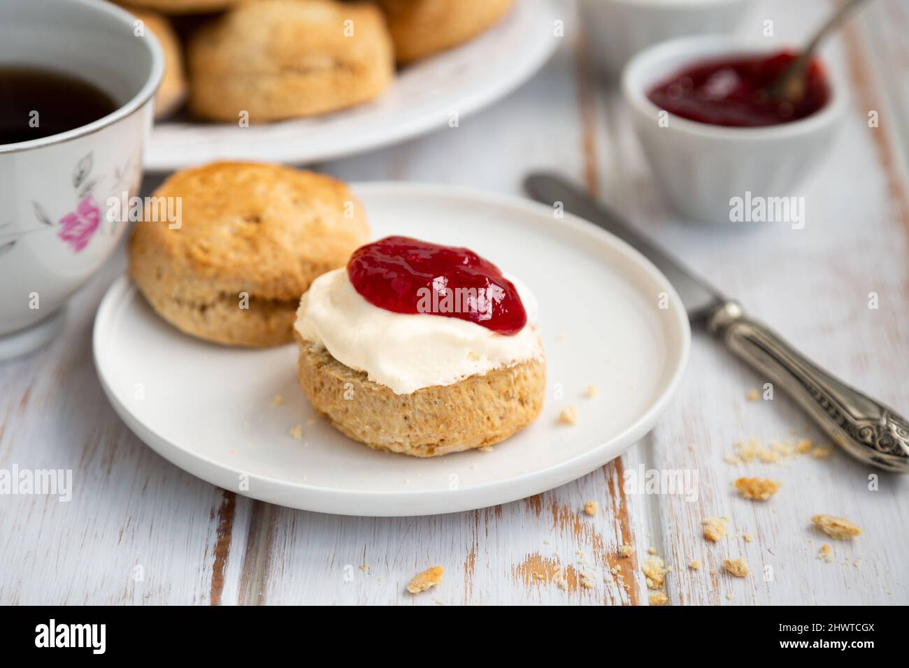 Traditional british scones with clotted cream and strawberry jam for ...
