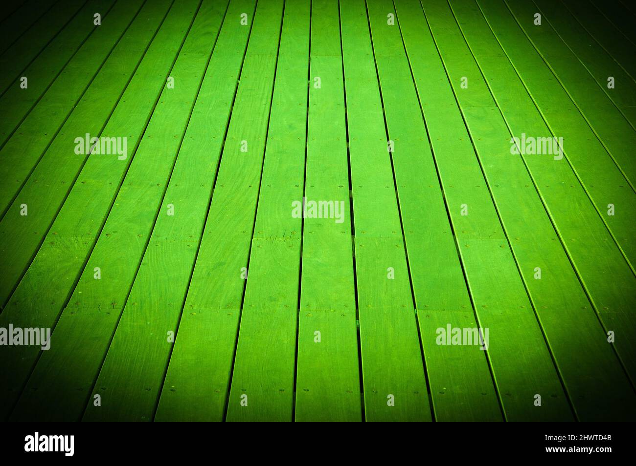 Weathered green color painted wooden floor lining. Outdoors. Vignette ...