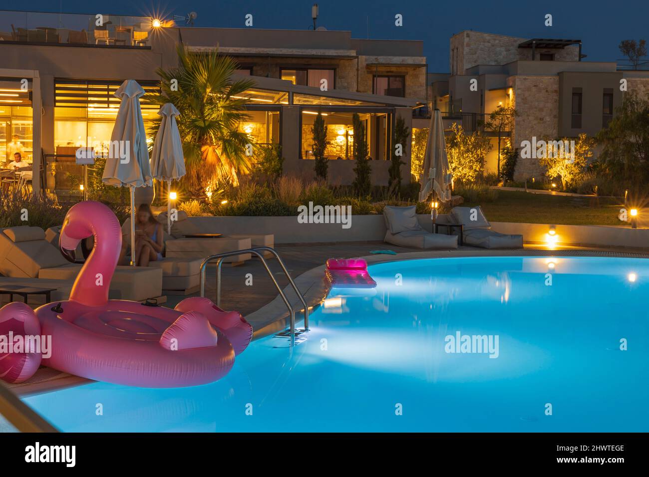 Beautiful night scenery overlooking hotel grounds with an outdoor pool ...