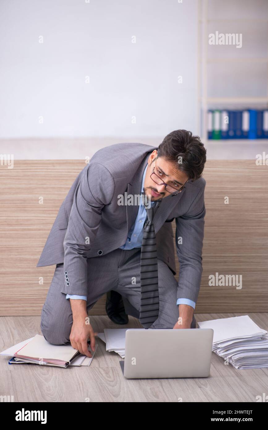 Young businessman employee working overtime at workplace Stock Photo ...