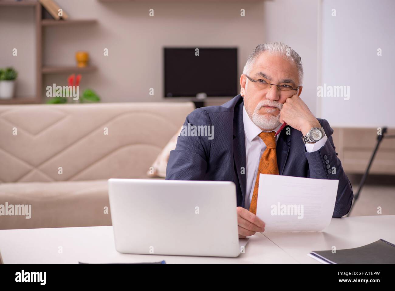 Old businessman employee working from home during pandemic Stock Photo ...
