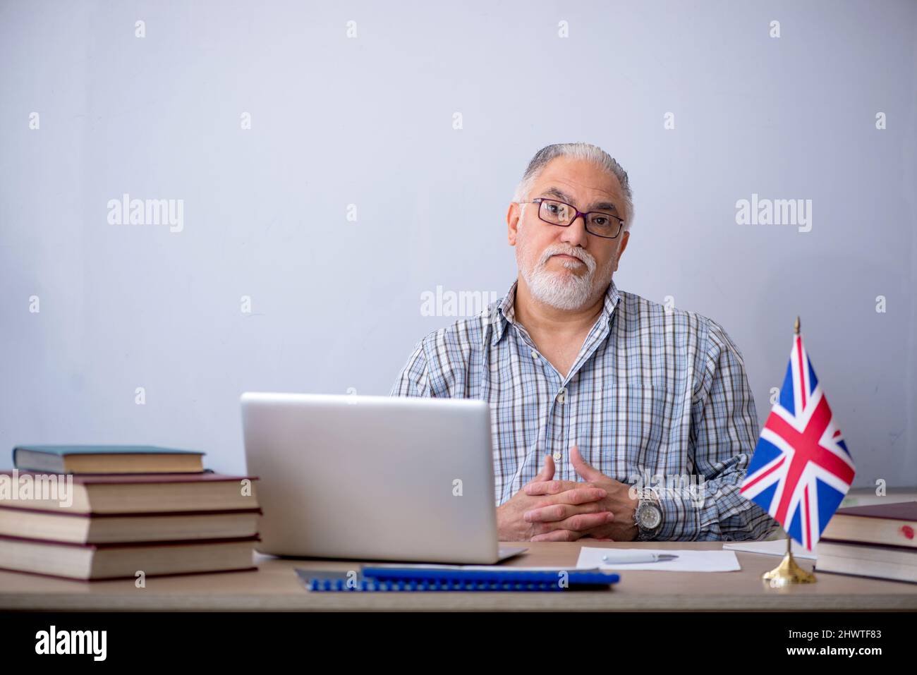 Aged english language teacher in the classroom Stock Photo - Alamy