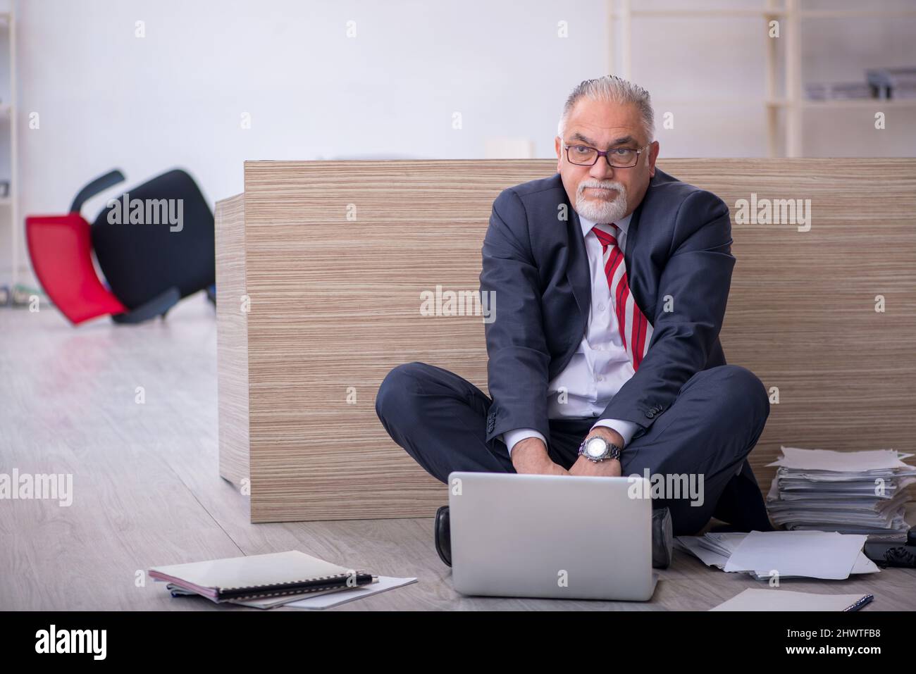 Old businessman employee working overtime at workplace Stock Photo - Alamy