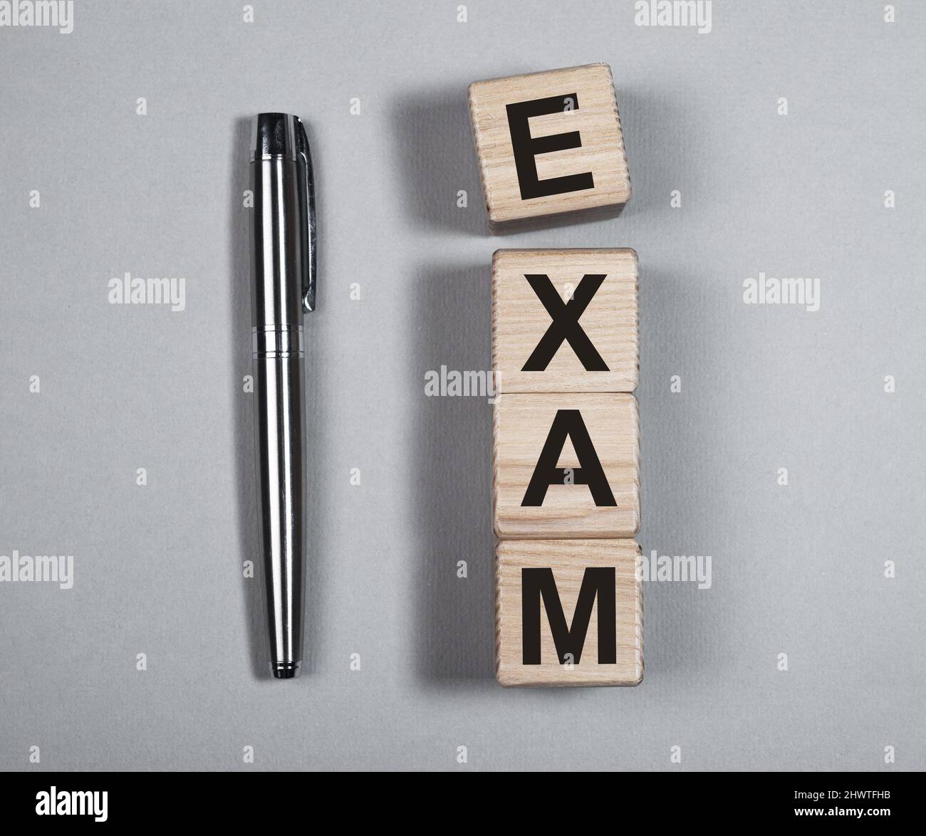 Word exam on wood cubes. Examination concept. photo Stock Photo - Alamy