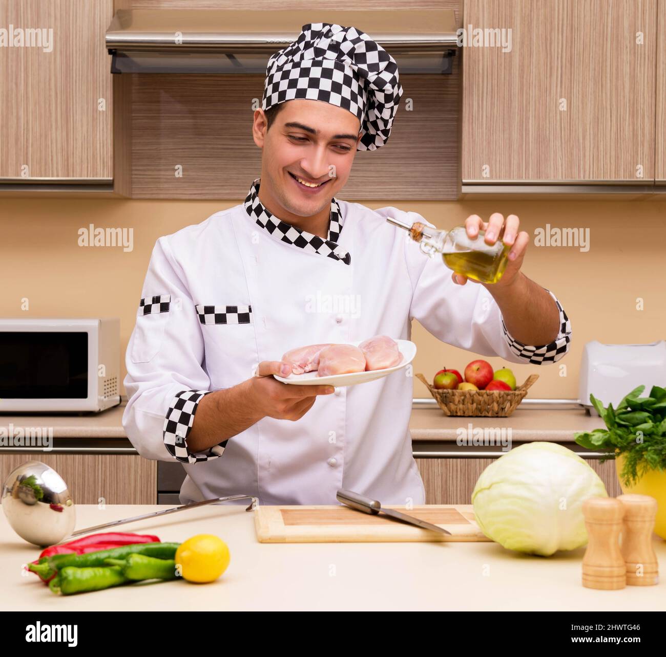 The young chef working in the kitchen Stock Photo - Alamy