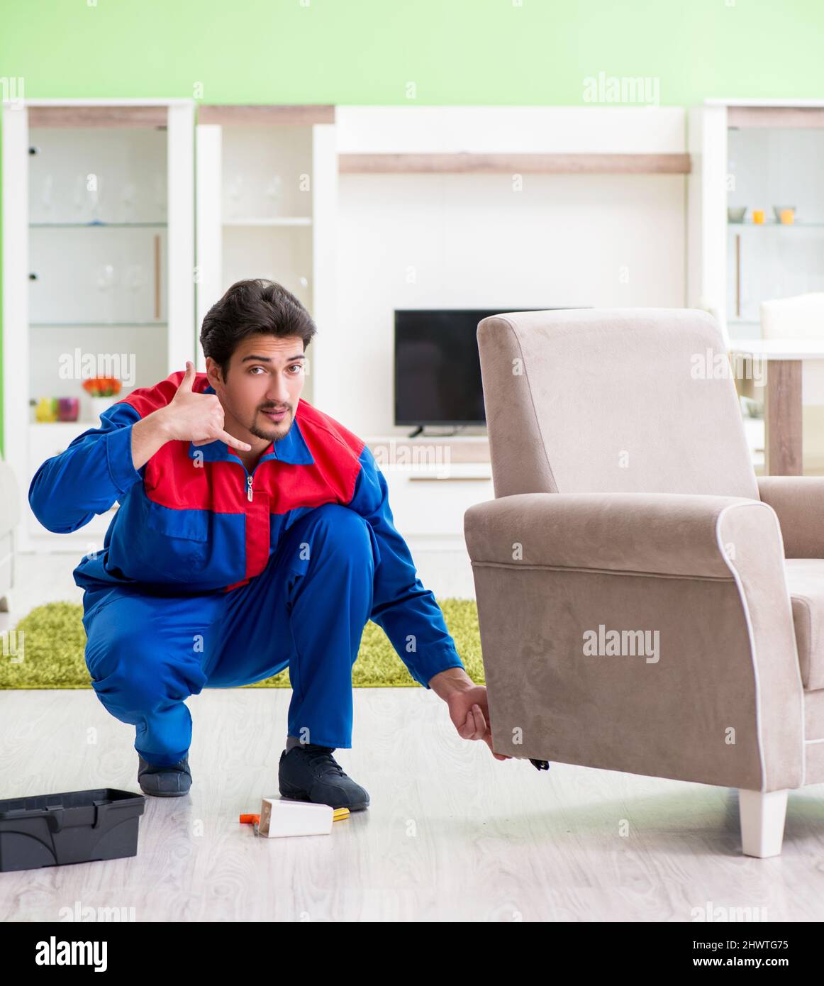The repair contractor repairing broken furniture at home Stock Photo ...