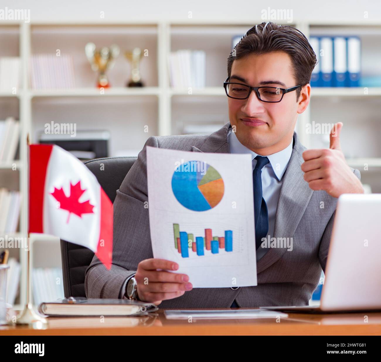 The businessman with canadian flag in office Stock Photo - Alamy