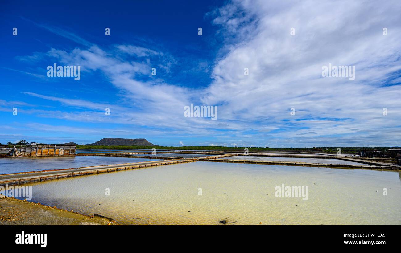 White pond for the extraction of salt. Blue sky and gorgeous clouds ...