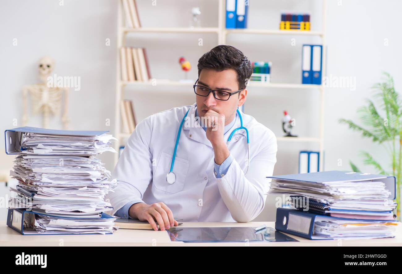The busy doctor with too much work in hospital Stock Photo - Alamy