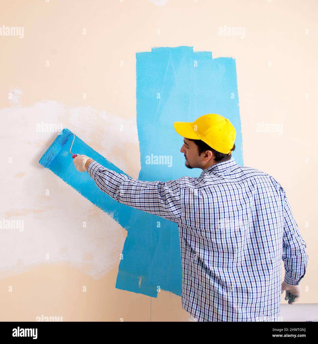 The painter man painting the wall at home Stock Photo - Alamy