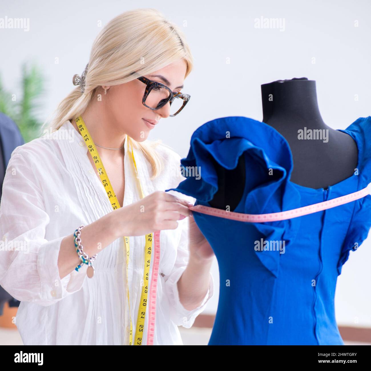 The woman tailor working on new dress designs Stock Photo - Alamy