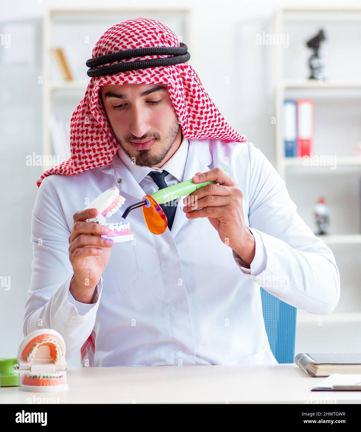 The arab dentist working on new teeth implant Stock Photo - Alamy