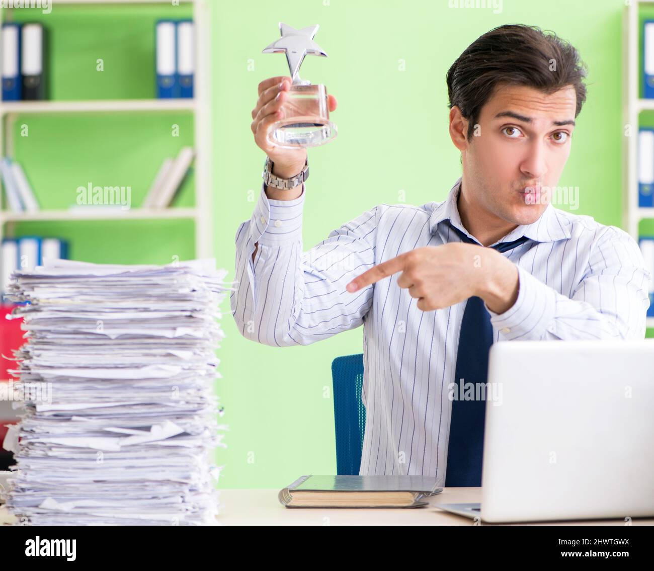 The businessman having problems with paperwork and workload Stock Photo ...
