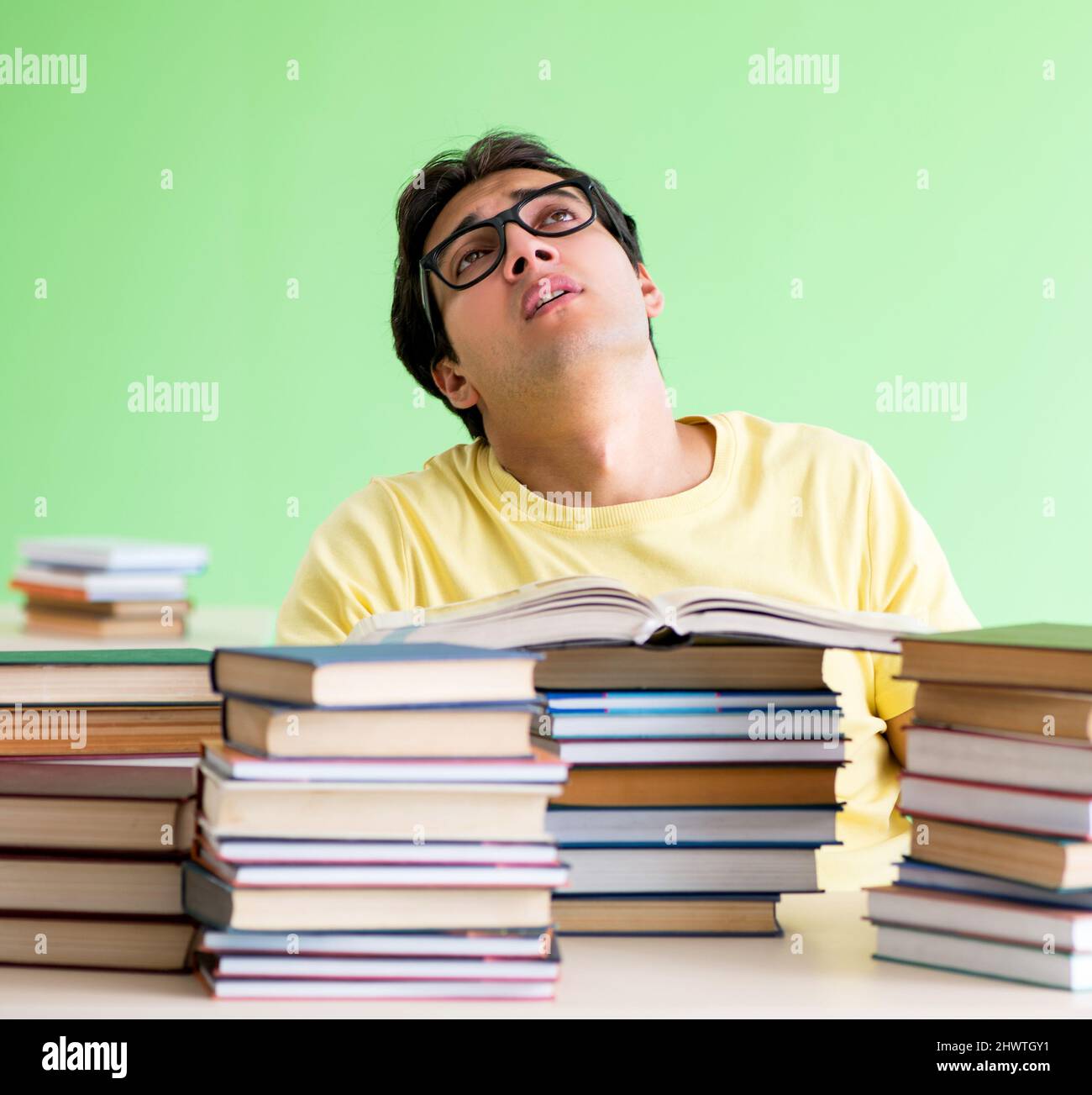 The student with too many books to read before exam Stock Photo - Alamy