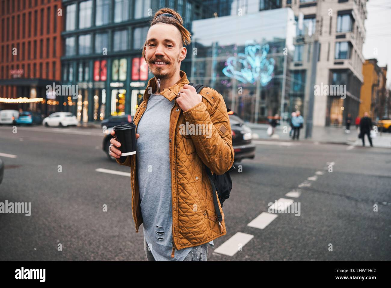 Young man crossing road hi-res stock photography and images - Alamy
