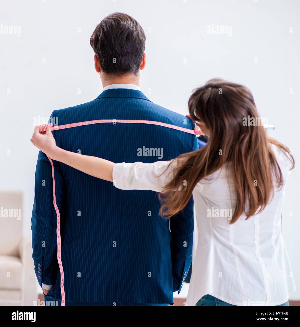 The professional tailor taking measurements for formal suit Stock Photo - Alamy