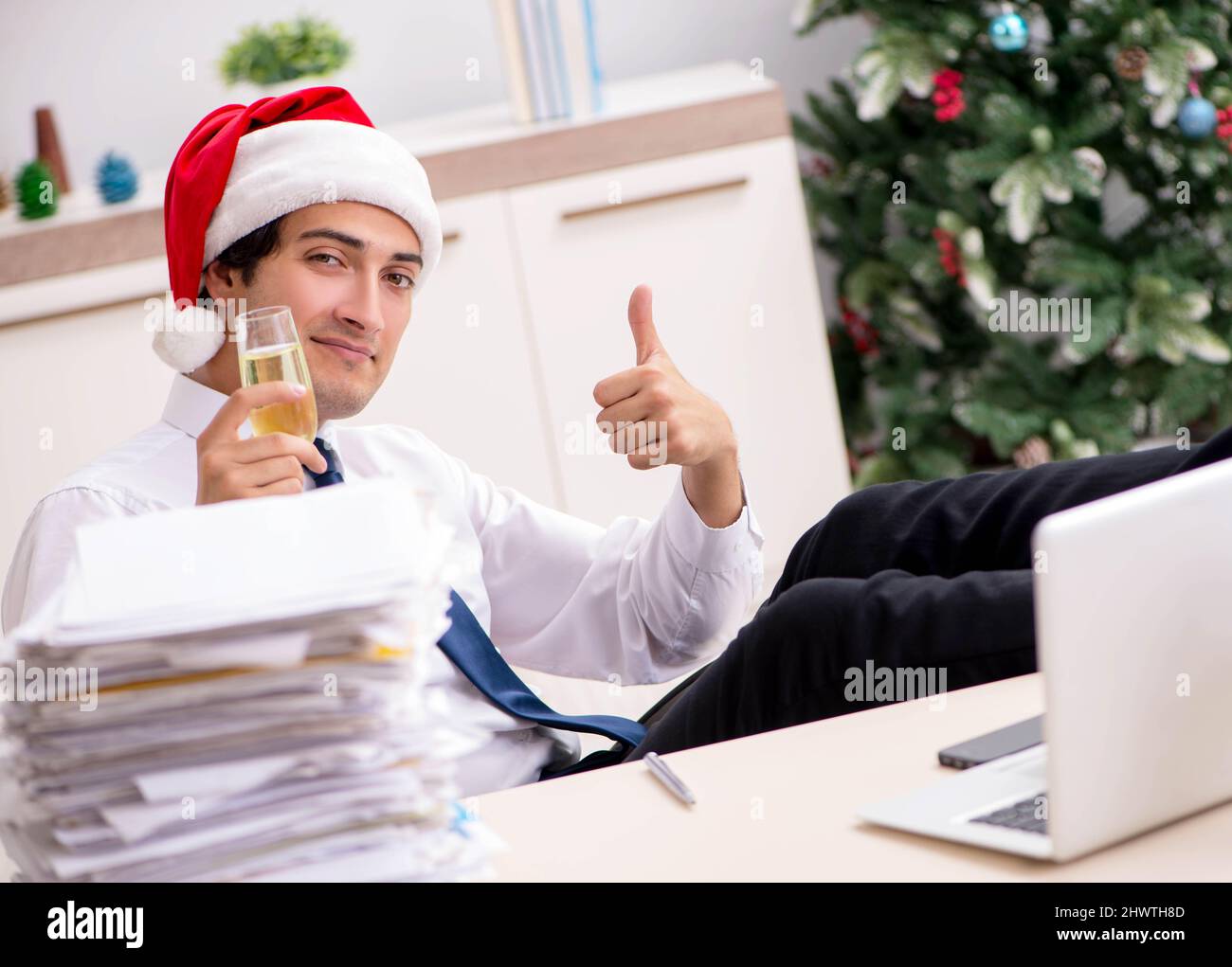 The young worker working in office on christmas shift Stock Photo - Alamy