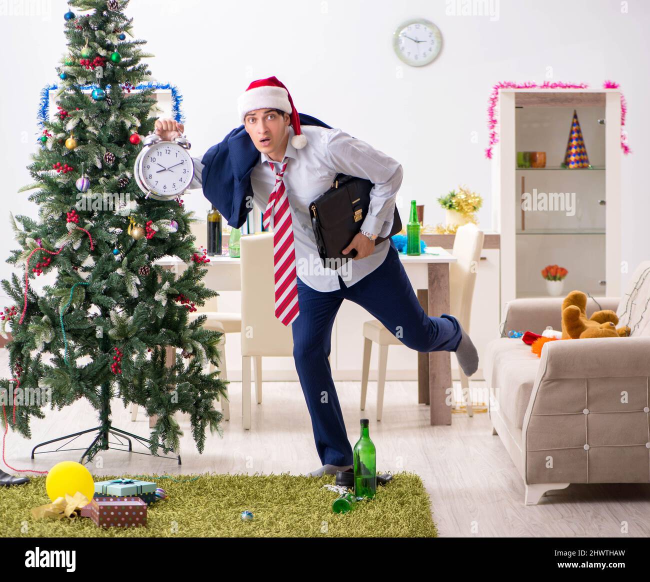 The young handsome employee celebrating christmas at workplace Stock ...