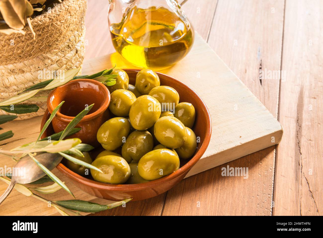 Still life with a bowl of olives, together with different seasonings ...