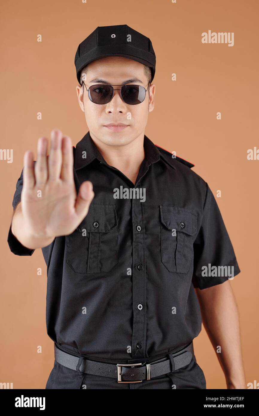 Studio portrait of serious security guard making stop gesture Stock ...