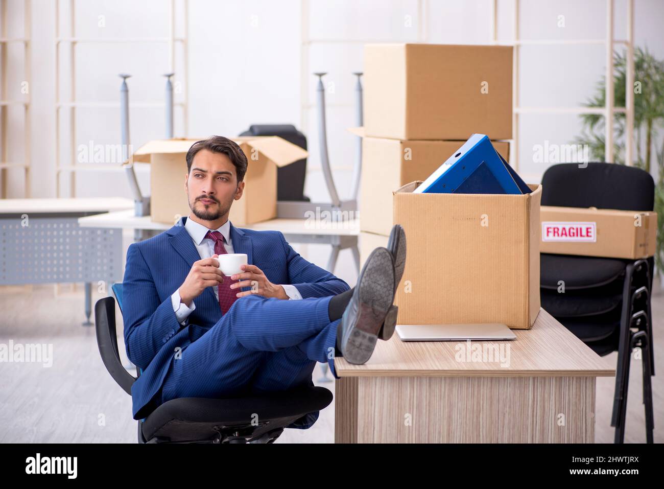 Young employee in relocation concept Stock Photo - Alamy