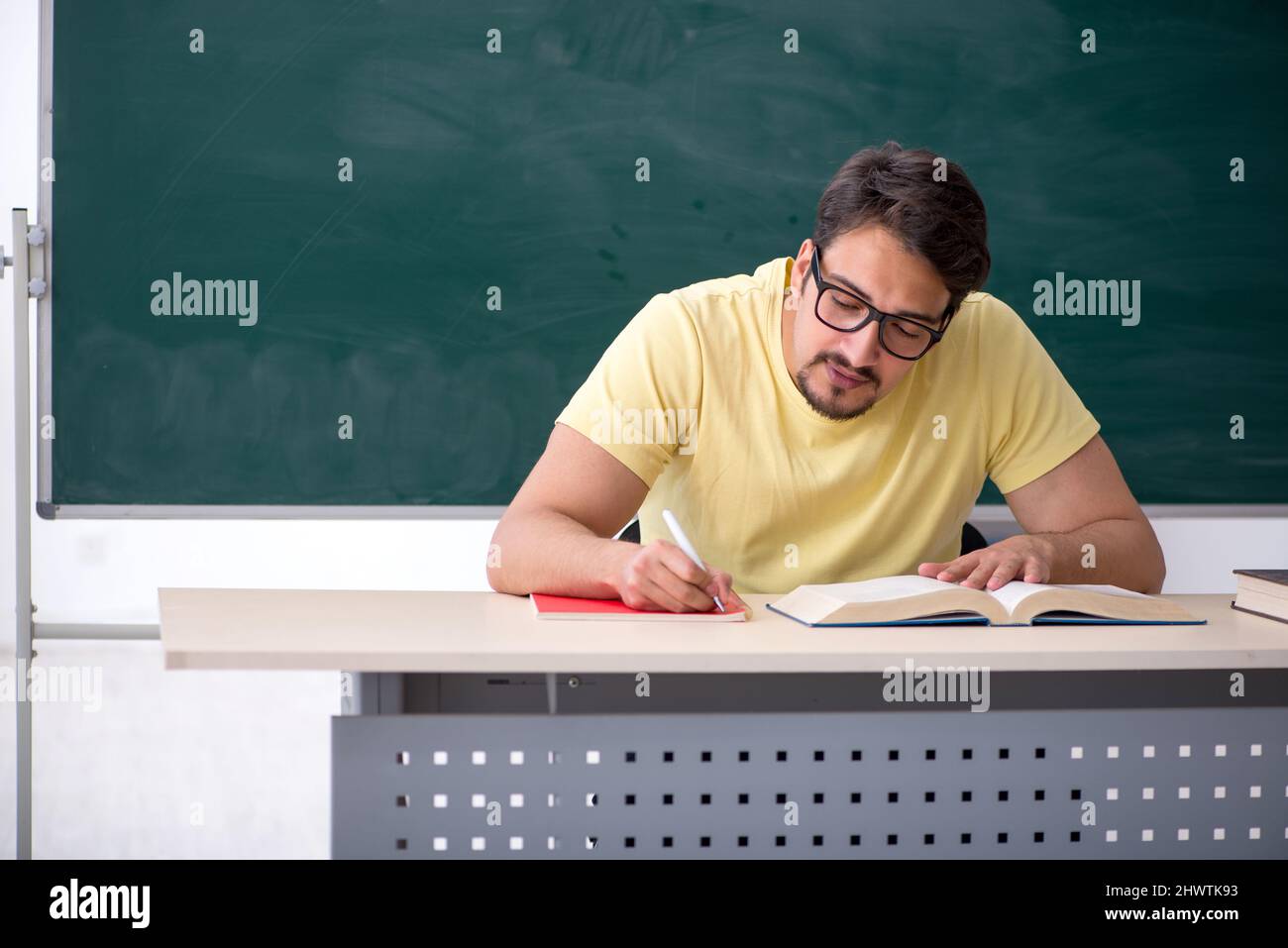 Young student in front of blackboard Stock Photo - Alamy